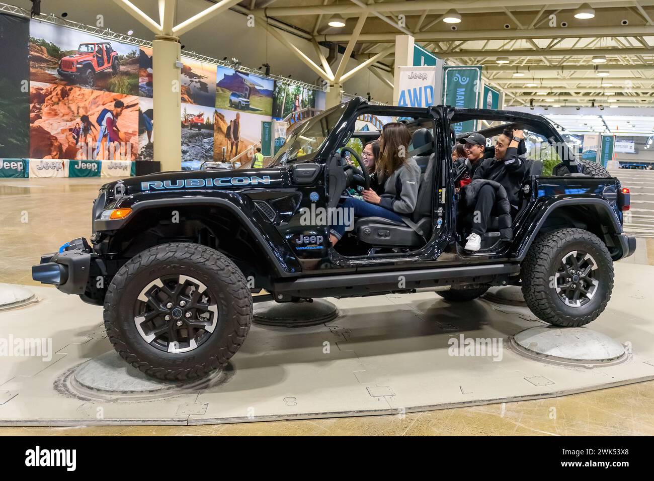 People driving a Jeep Wrangler vehicle in an closed course with ...