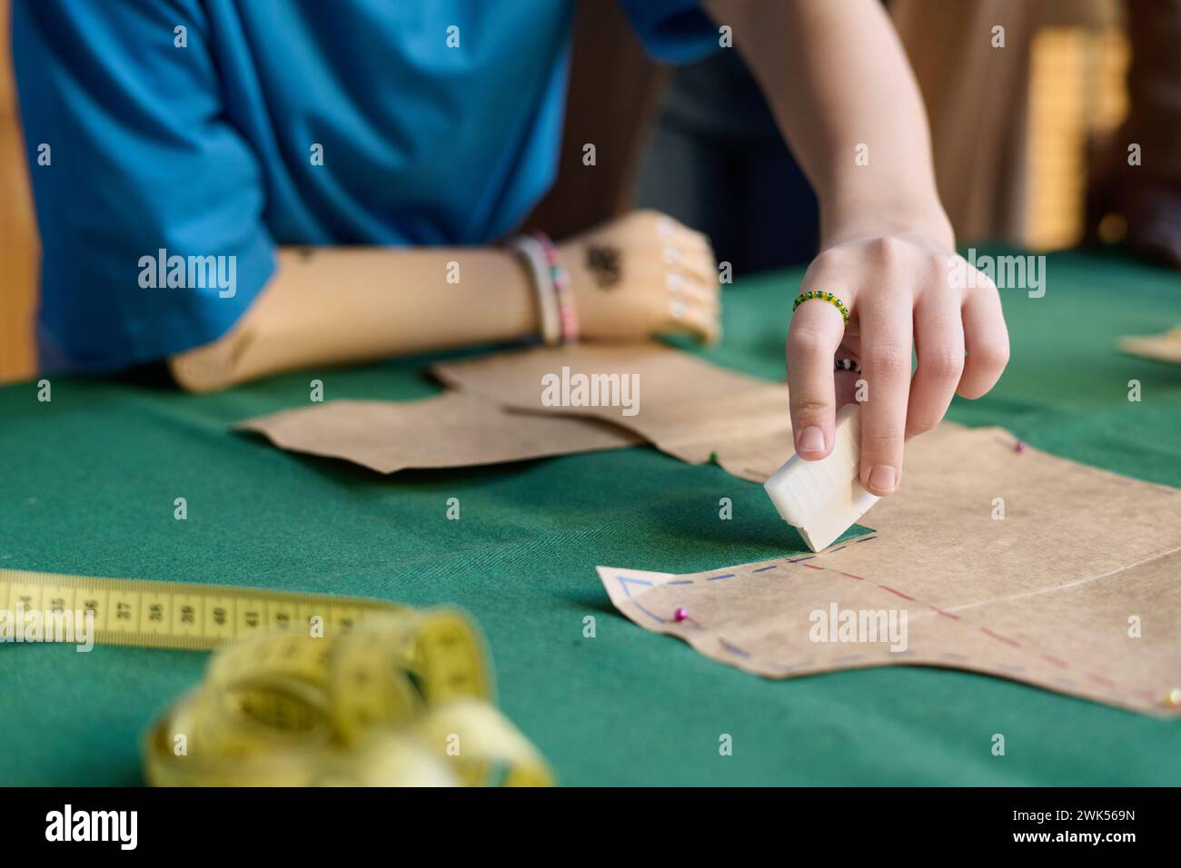 Close up of unrecognizable girl with disability making clothing and ...