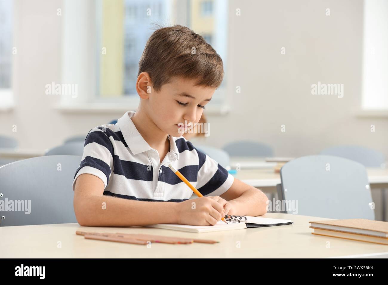 Cute little boy studying in classroom at school Stock Photo - Alamy