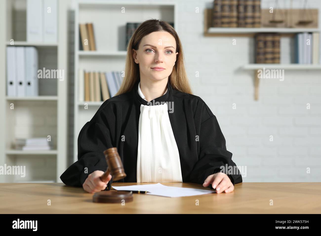 Judge striking wooden mallet at table indoors Stock Photo - Alamy