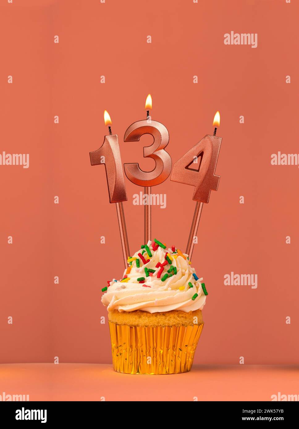 Birthday cupcake with candle number 134 - Coral fusion background Stock ...