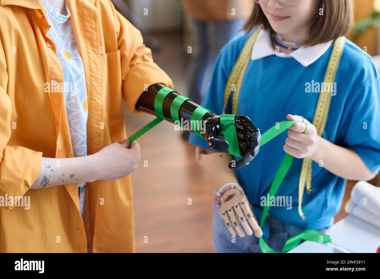Close up of two unrecognizable teen girls decorating prosthetics with ...