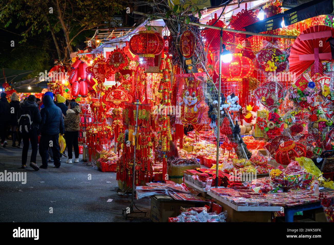 Buying brightly colored decorations for Tet Celebrations at the Hanoi ...