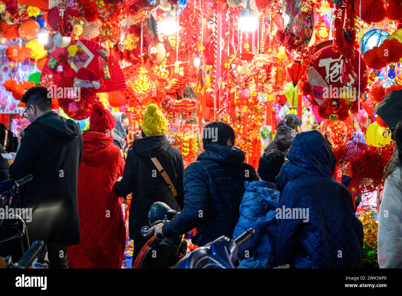 Buying brightly colored decorations for Tet Celebrations at the Hanoi ...