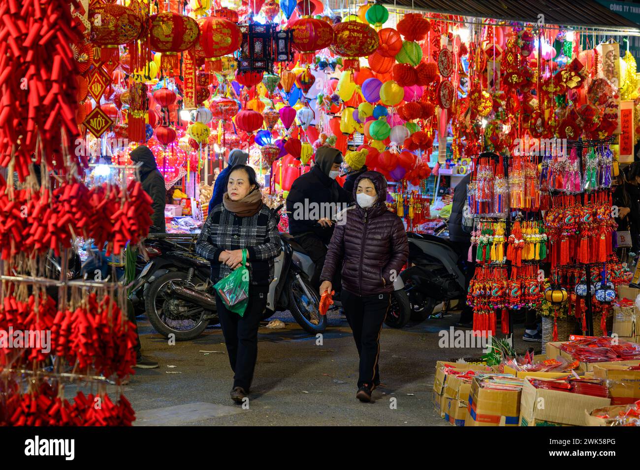 Buying brightly colored decorations for Tet Celebrations at the Hanoi ...