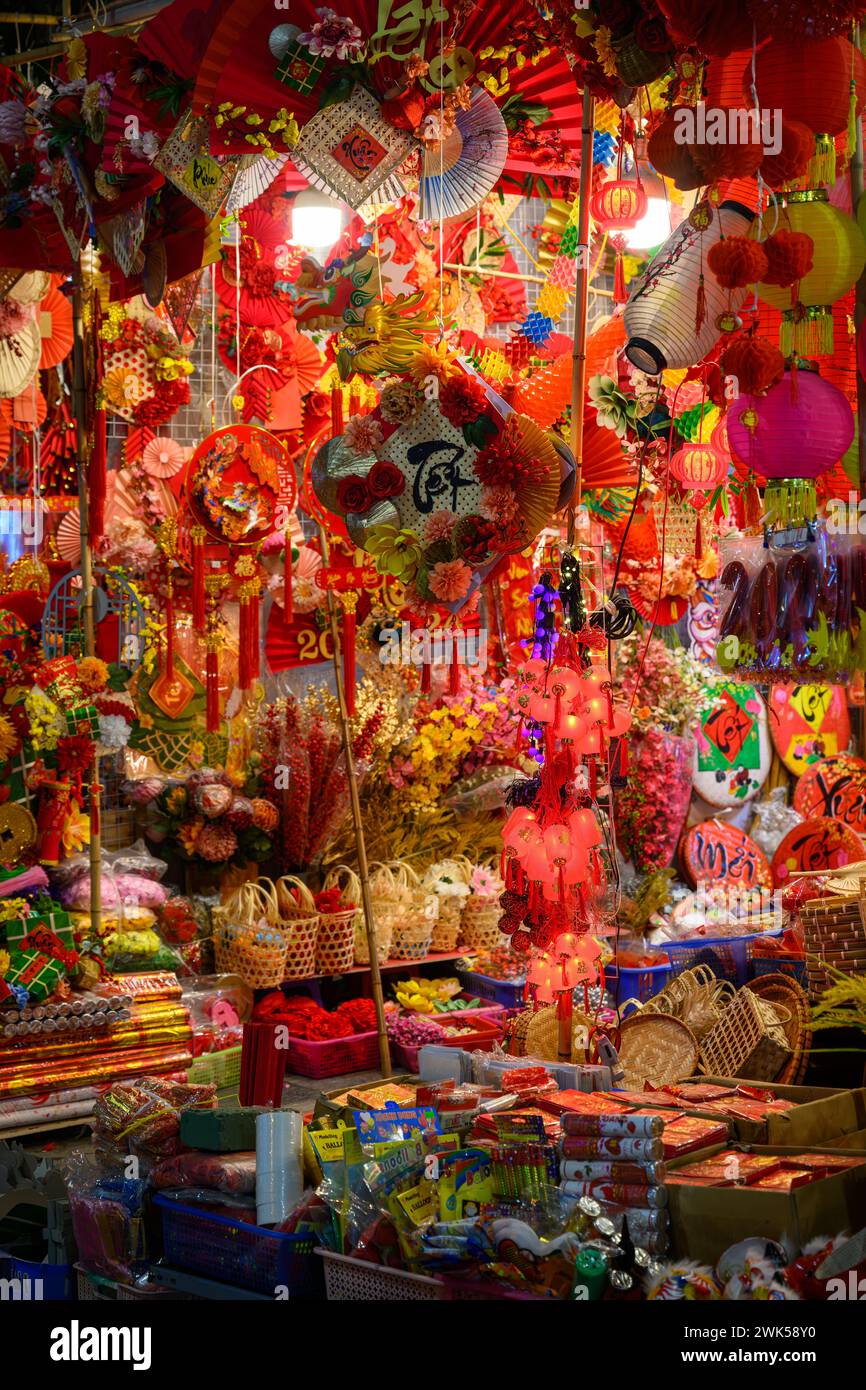 Buying brightly colored decorations for Tet Celebrations at the Hanoi ...