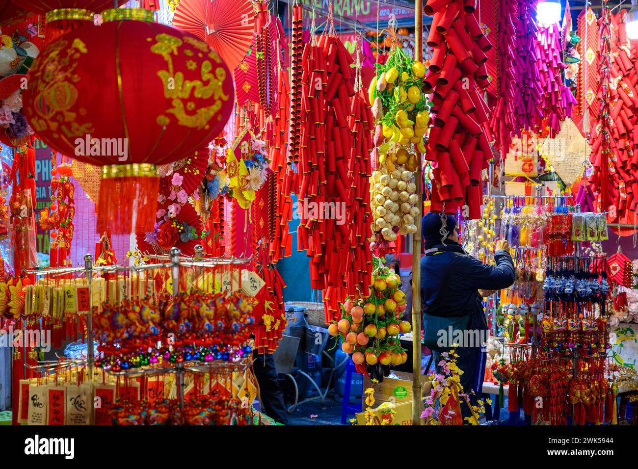 Buying brightly colored decorations for Tet Celebrations at the Hanoi ...