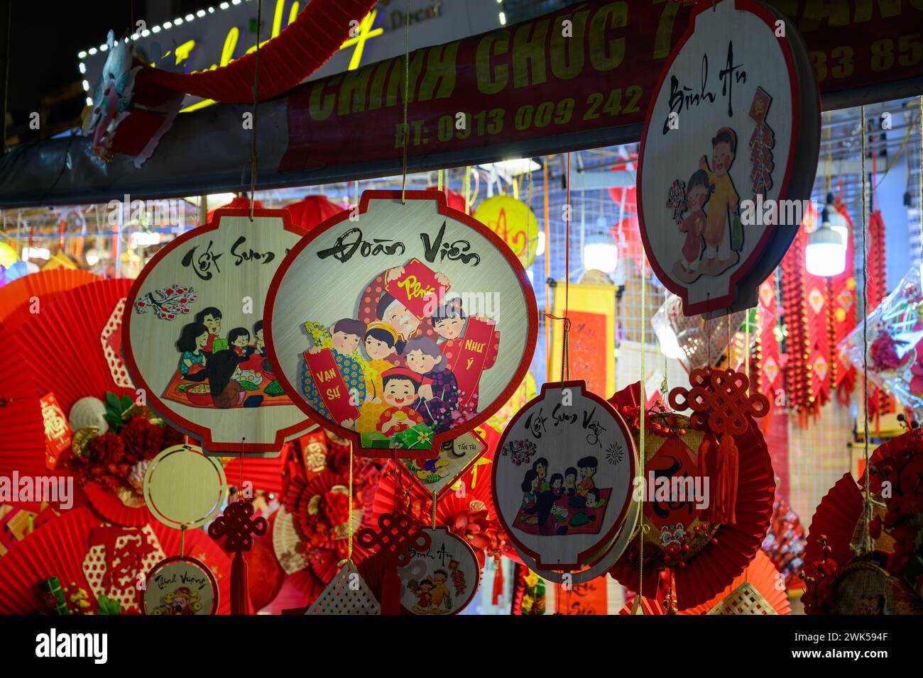 Buying brightly colored decorations for Tet Celebrations at the Hanoi ...