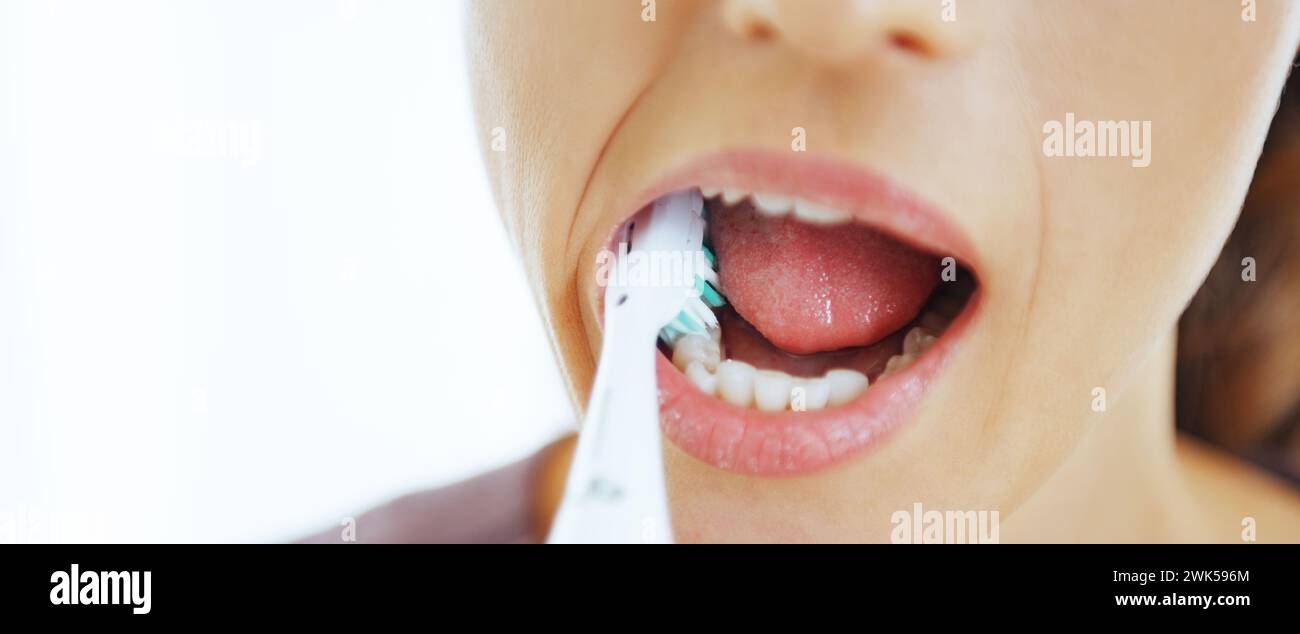 Closeup on young woman brushing teeth Stock Photo - Alamy