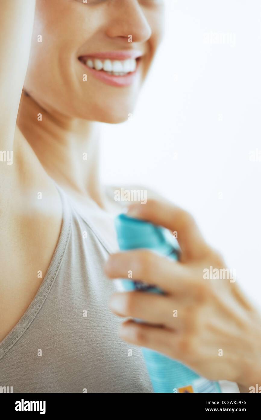 Closeup on young woman applying deodorant on underarm Stock Photo - Alamy