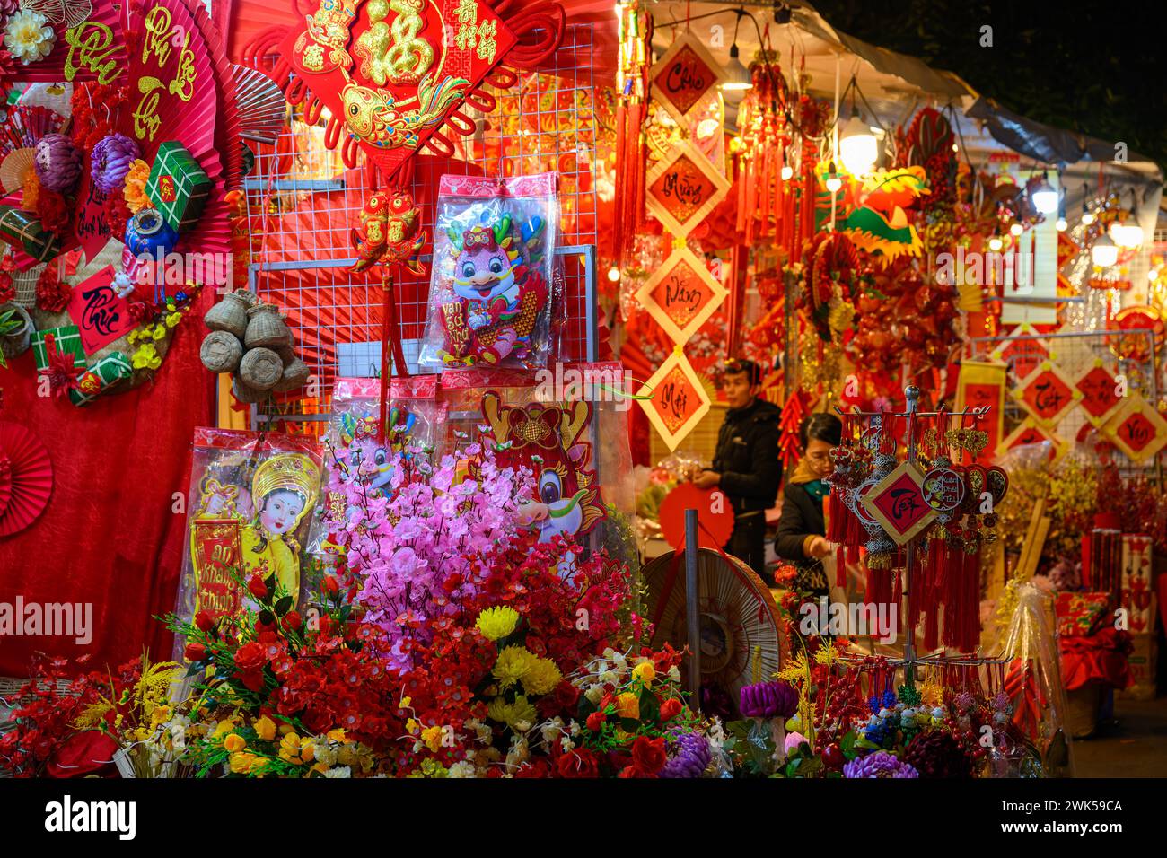 Buying brightly colored decorations for Tet Celebrations at the Hanoi ...