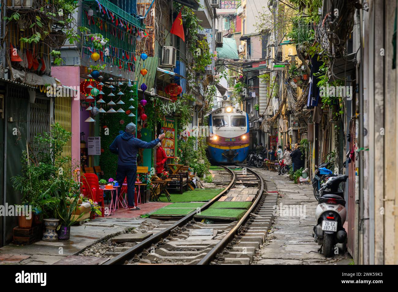 An approaching Vietnamese railway train on Train Street, Hanoi, Vietnam ...