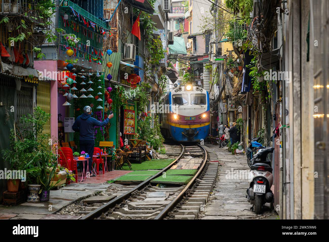 An approaching Vietnamese railway train on Train Street, Hanoi, Vietnam ...