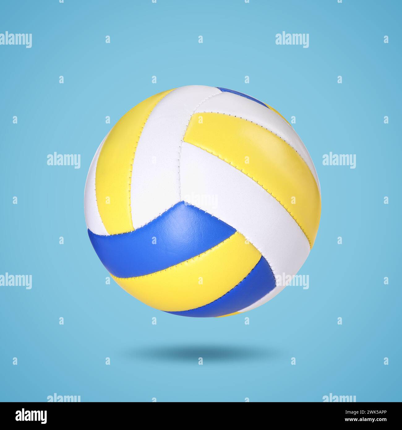 One volleyball ball in air on light blue background Stock Photo - Alamy