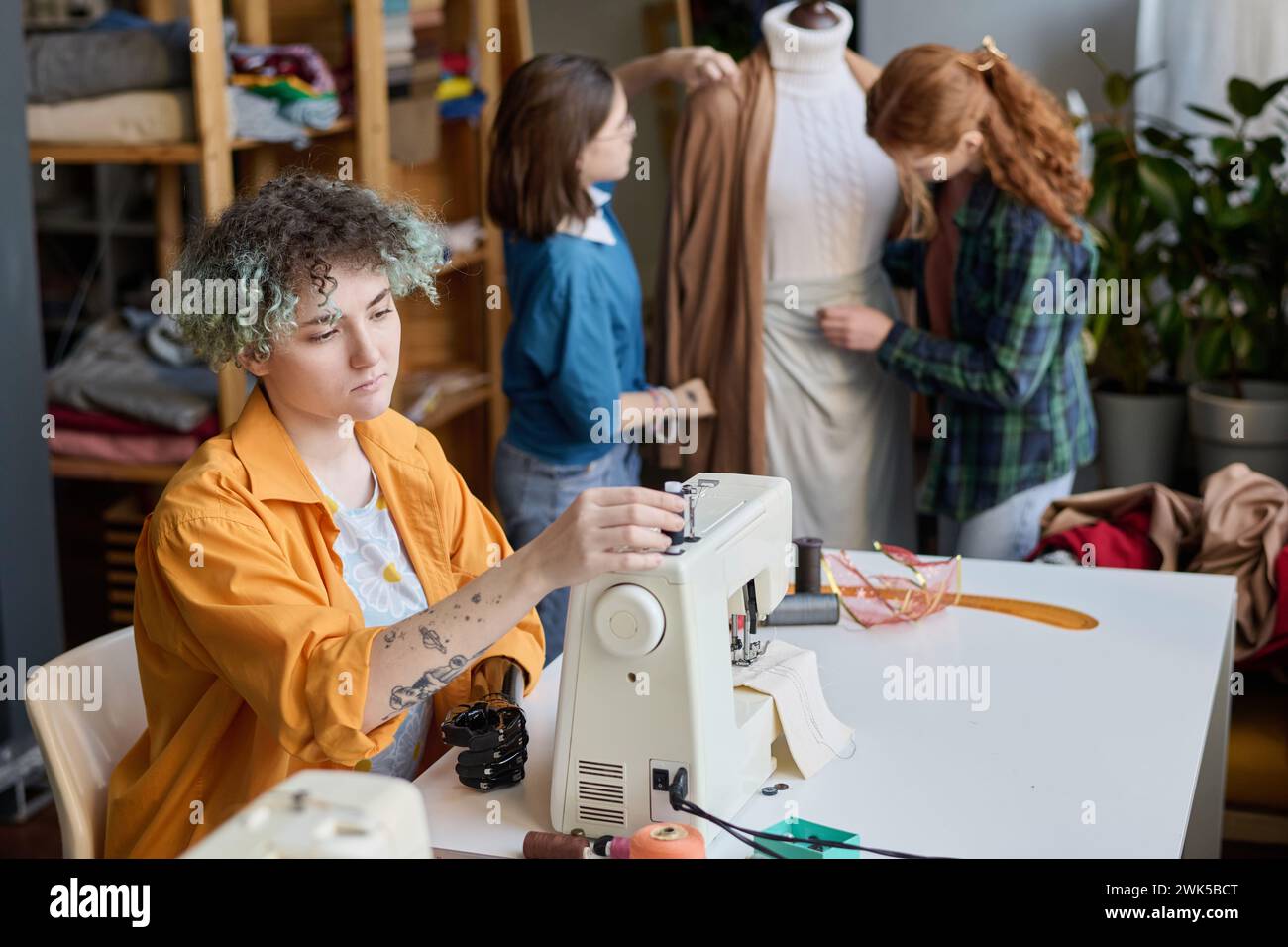 Side view portrait of young woman with prosthetic hand setting up ...