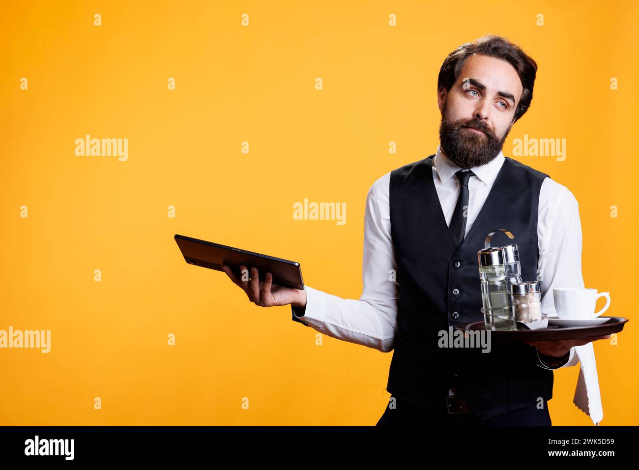 Skilled employee gives menu on tablet to customers at five star ...