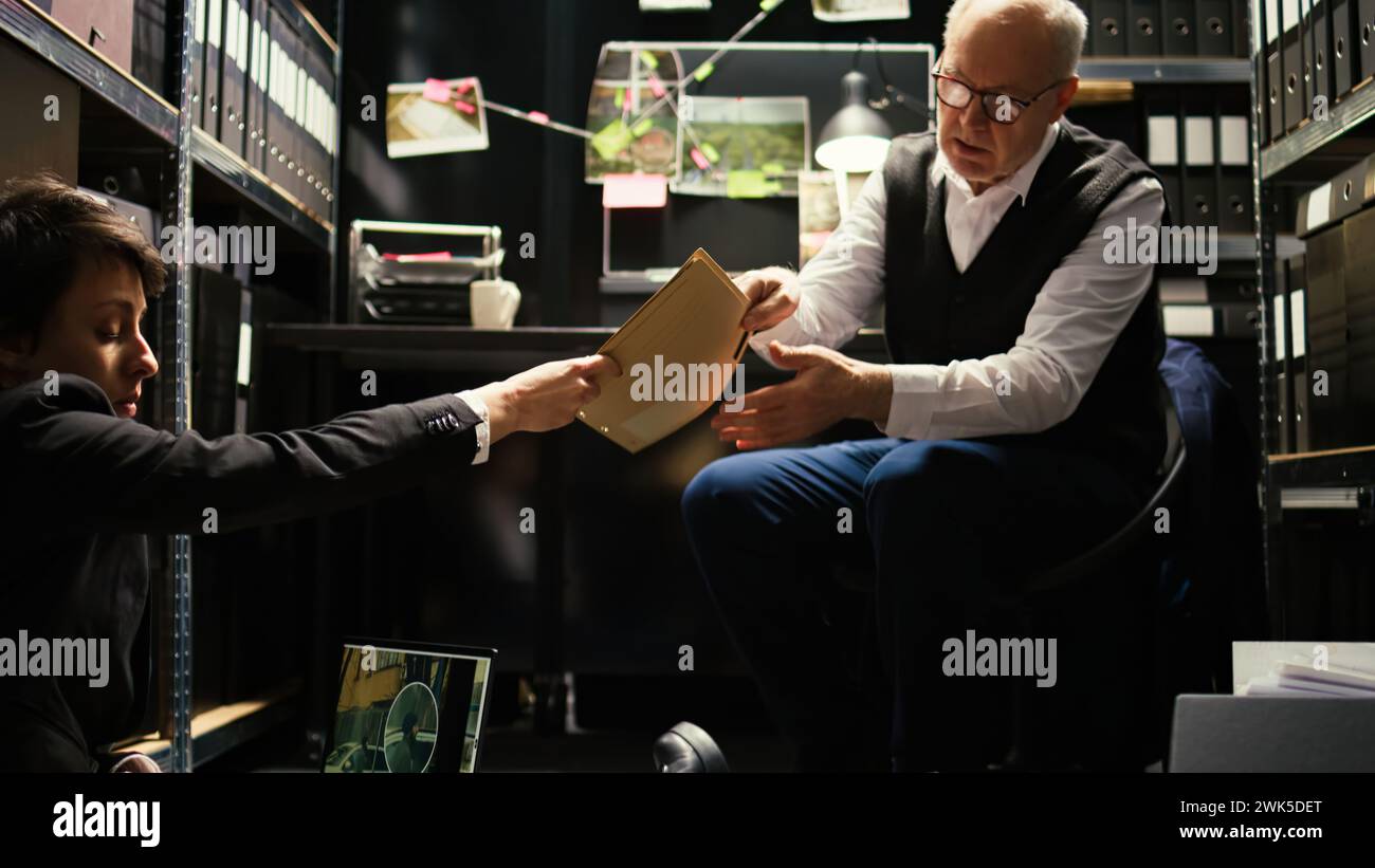 Two law agents examine case clues, doing teamwork to discover new ...