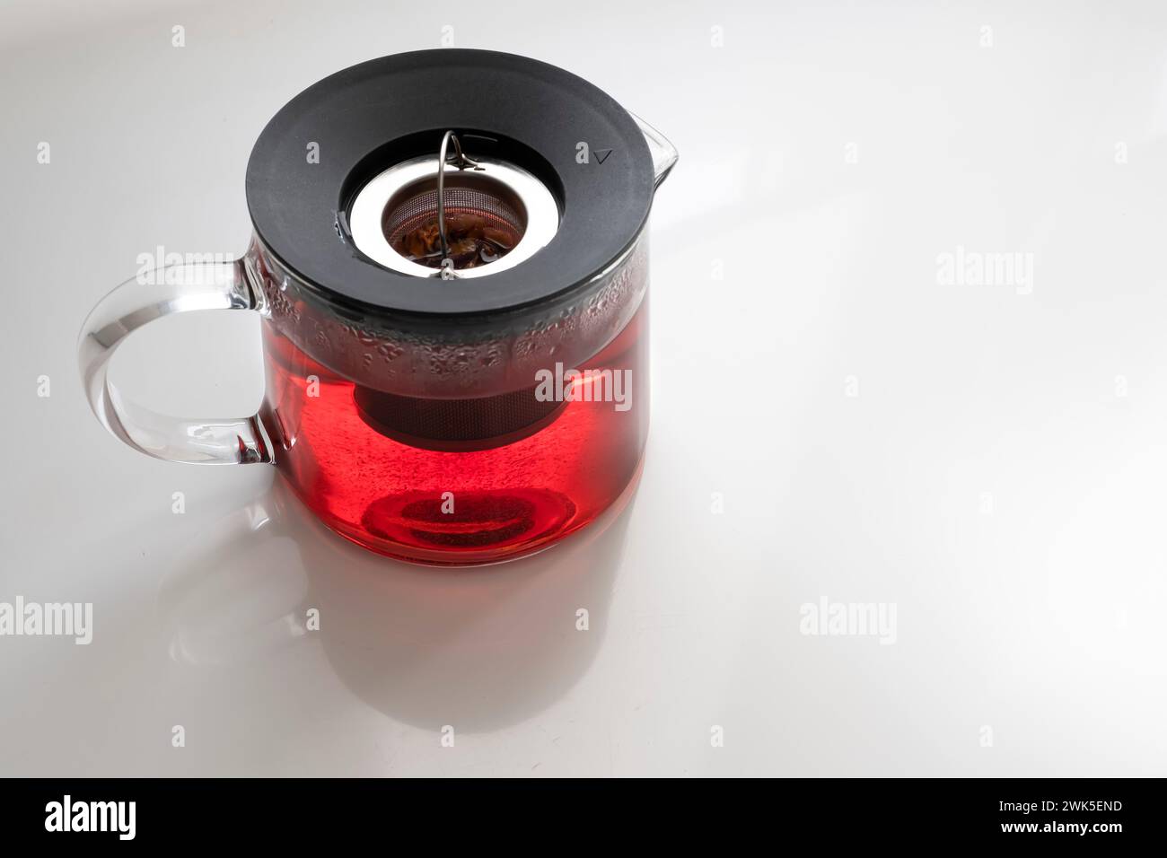 a glass teapot with a fruit infusion, infuser pitcher with a strawberry ...