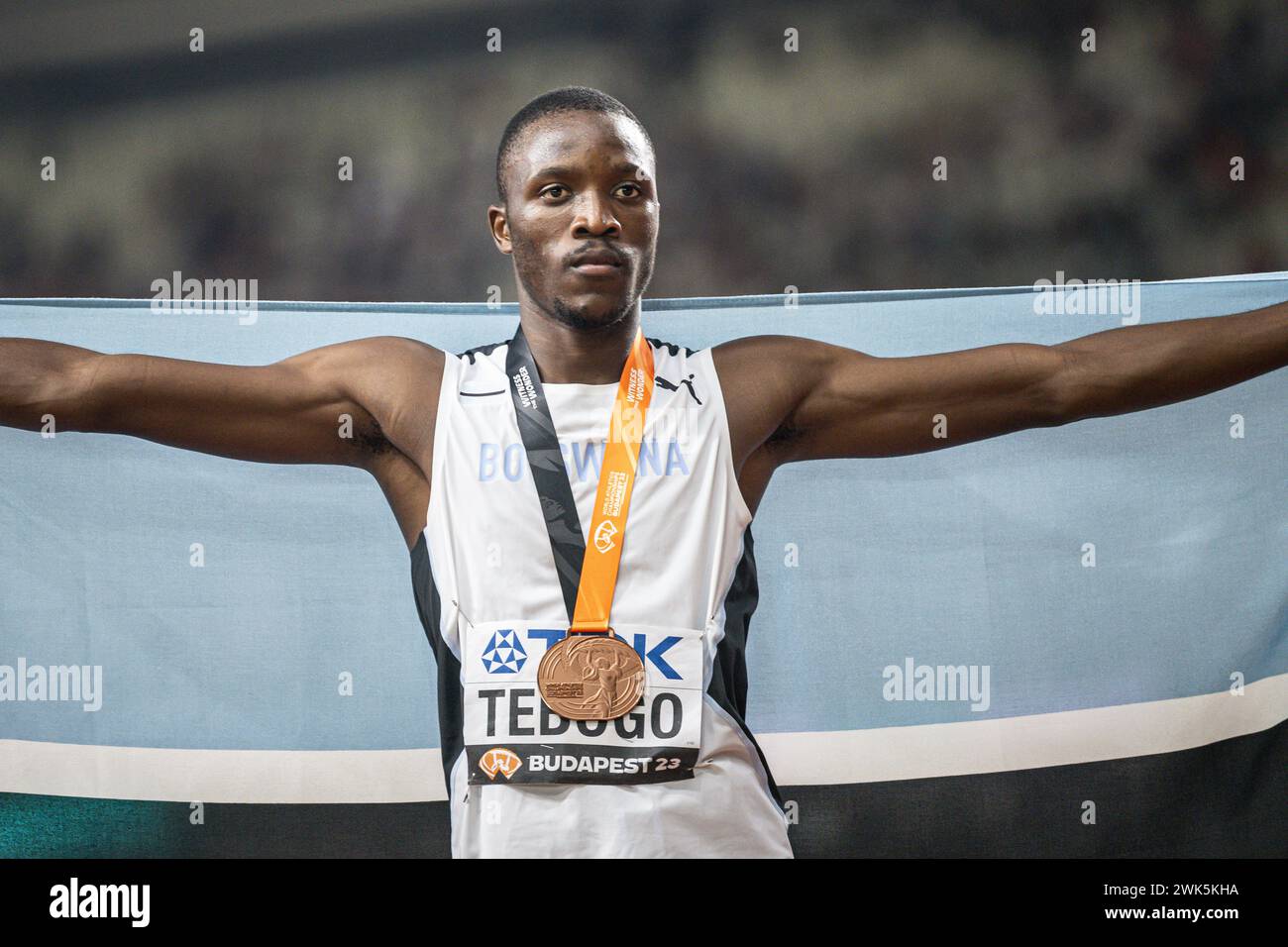 Letsile TEBOGO celebrating his medal with the flag in the Budapest 2023 ...
