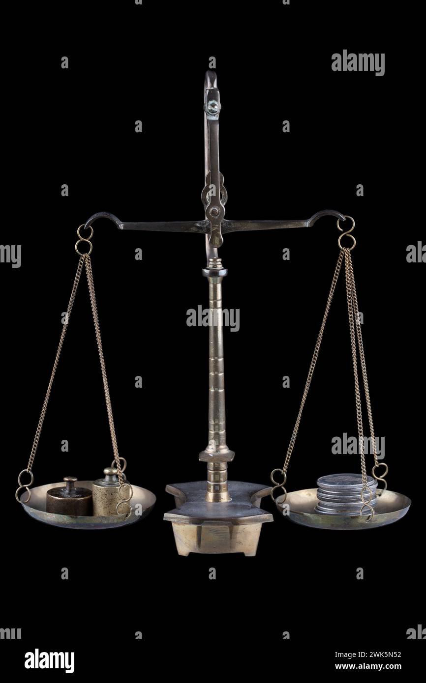 Bronze traditional balance scale set with weights and silver coins on ...