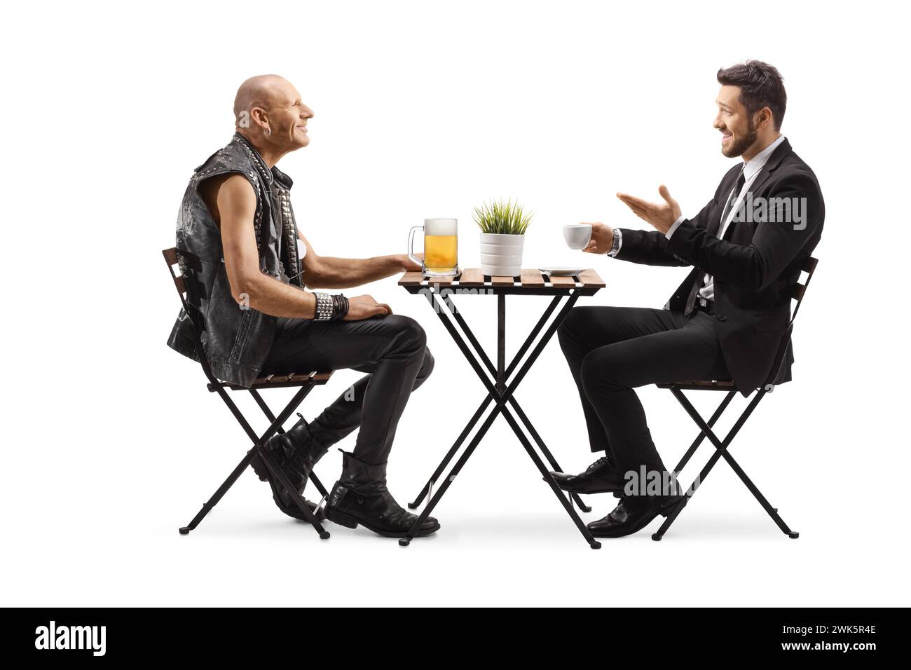 Punk with a pint of beer at a cafe and a businessman with a cup of ...