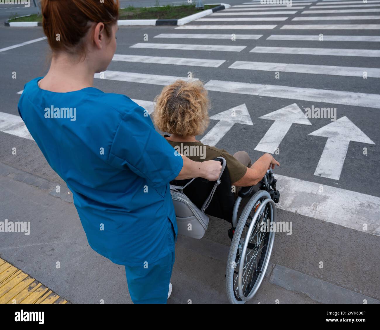 Helping elderly cross street hi-res stock photography and images - Alamy