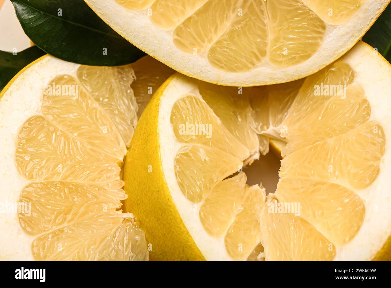 Sweet pomelo slices and leaves as background Stock Photo - Alamy