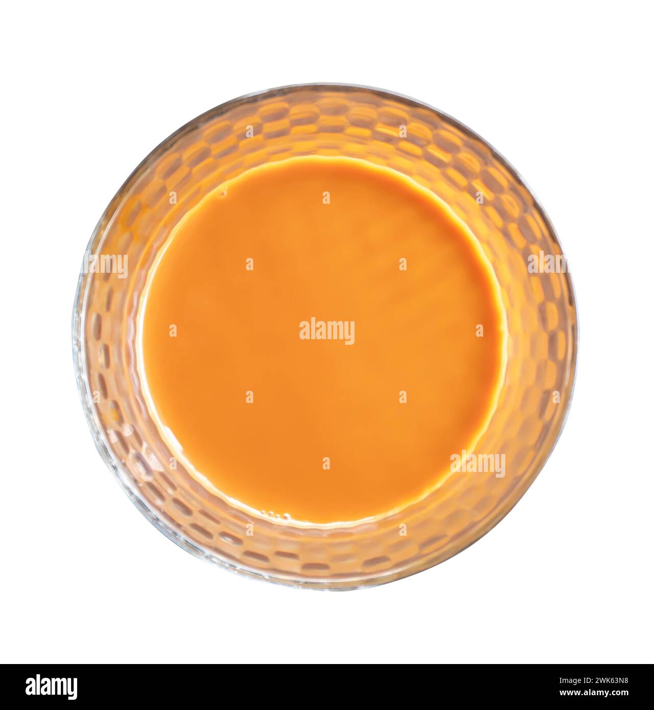 Top view of hot orange or yellow condensed milk tea in transparent ...