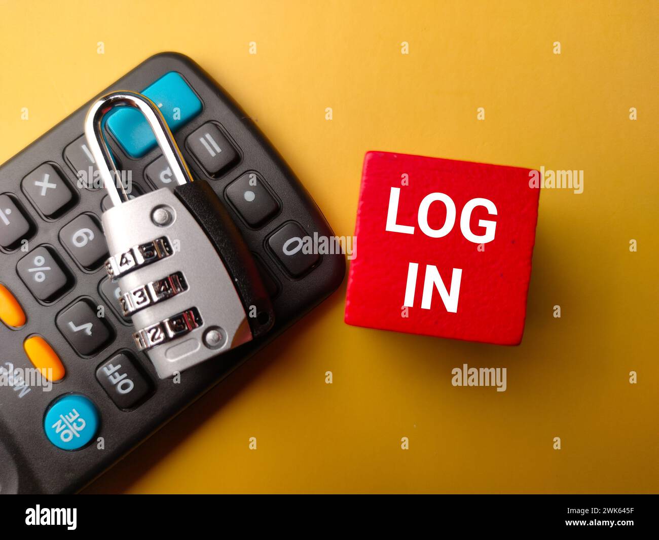 Top view padlock and calculator with text LOG IN on yellow background ...
