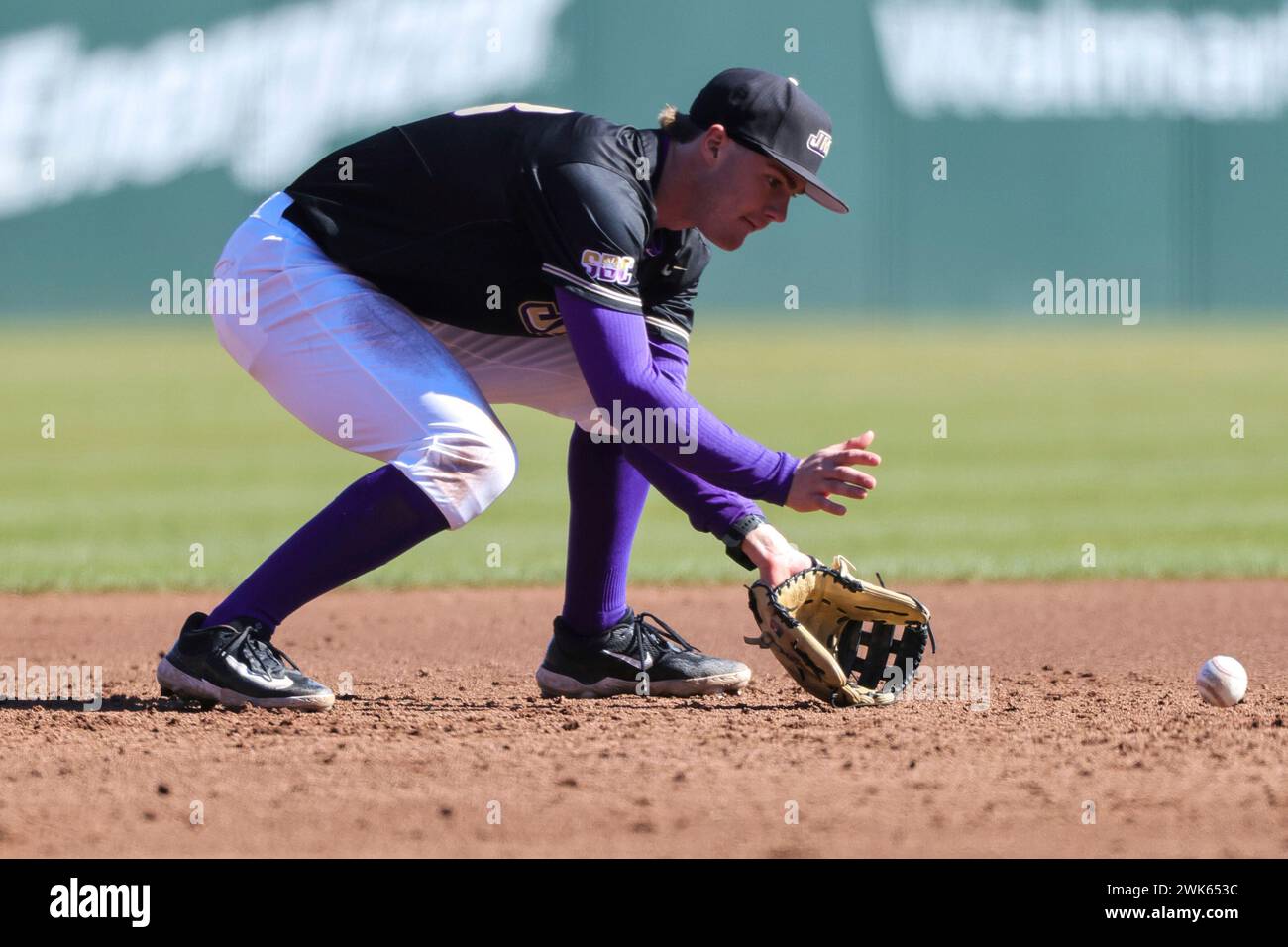 February 18, 2024: Wyatt Pfeifer #23 JMU infielder goes down to scoop a ...