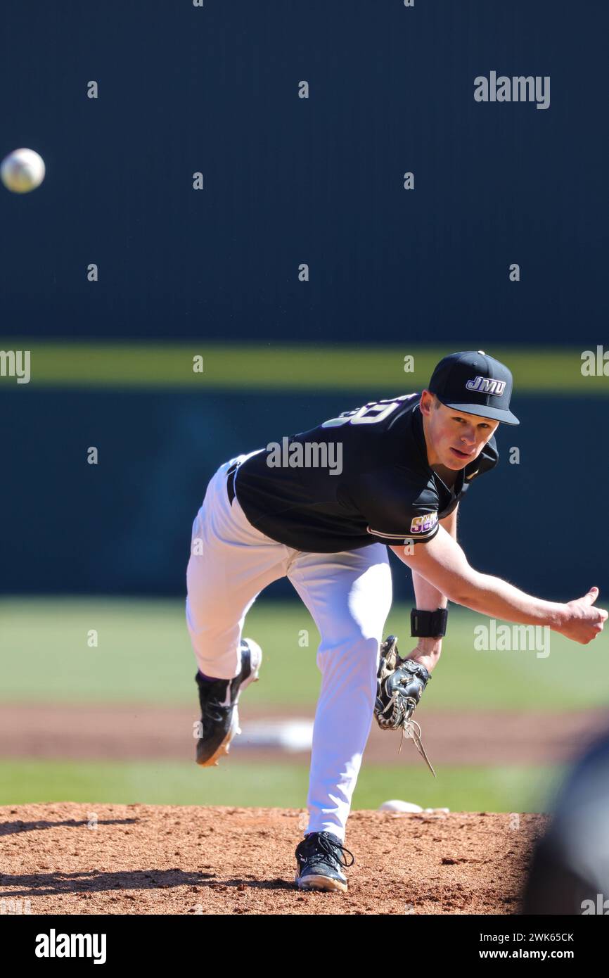 February 18, 2024: Ryan Murphy #18 JMU pitcher watches a ball as it ...