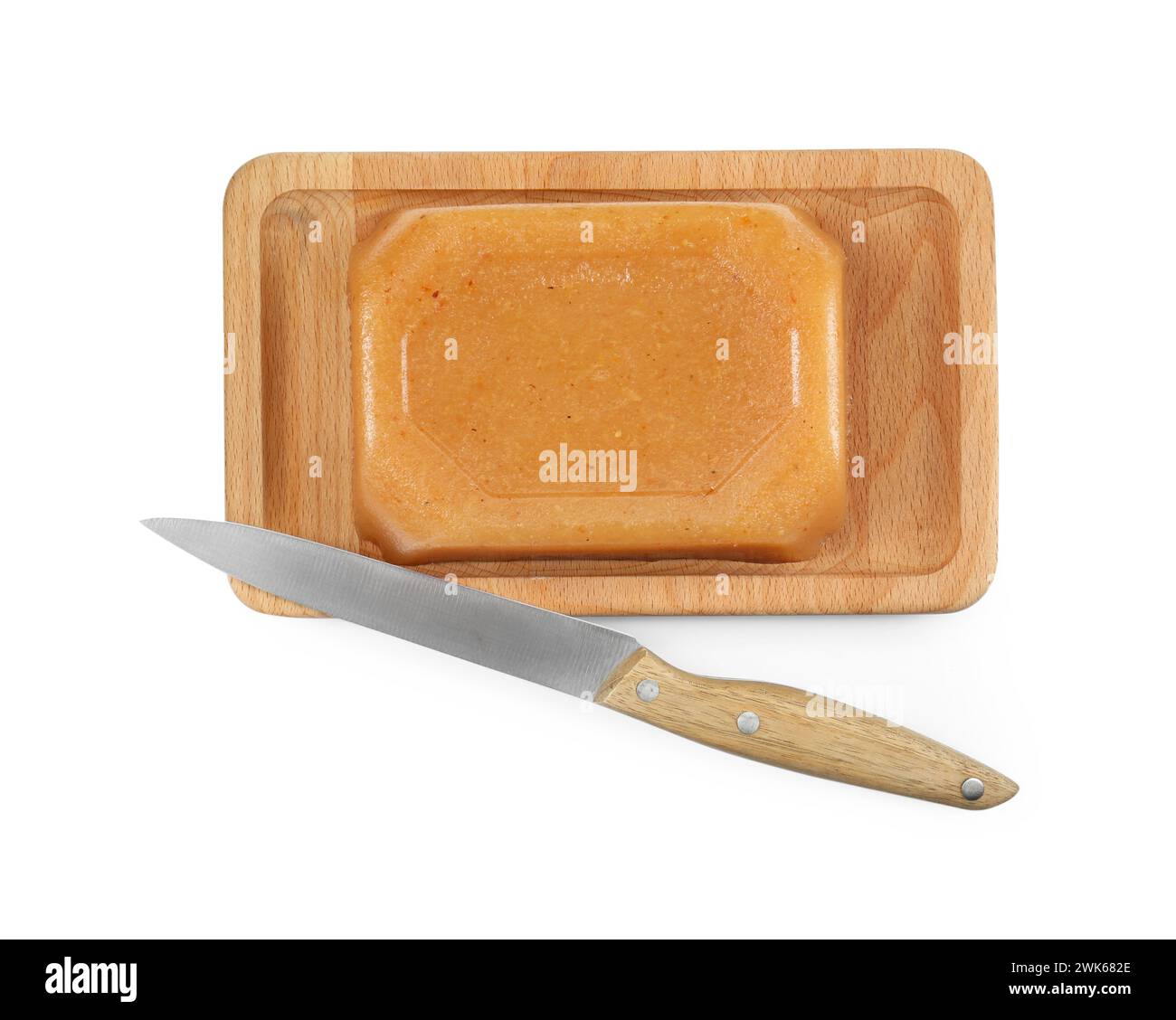 Delicious sweet quince paste and knife isolated on white, top view ...