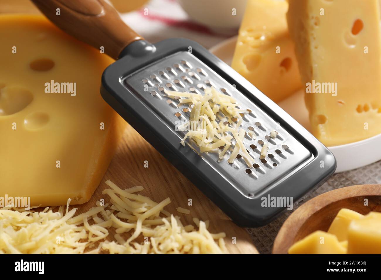 Grated, cut cheese and grater on table, closeup Stock Photo - Alamy