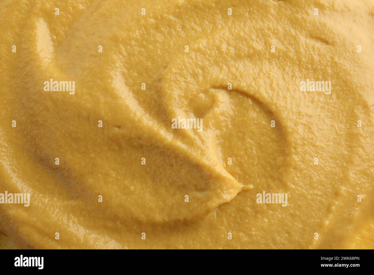 Fresh tasty mustard sauce as background, top view Stock Photo - Alamy