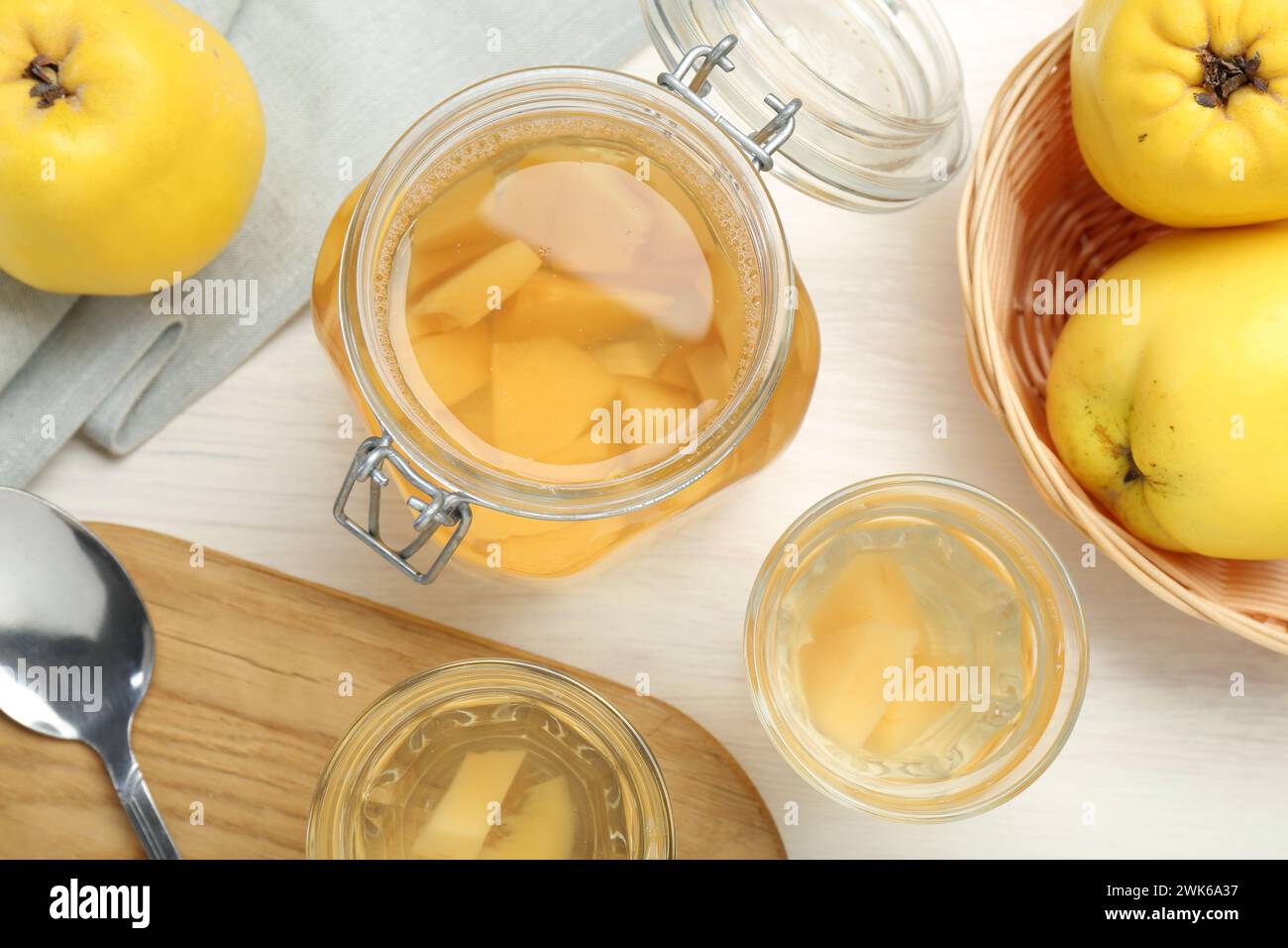 Delicious quince drink, fresh fruits and spoon on white wooden table ...