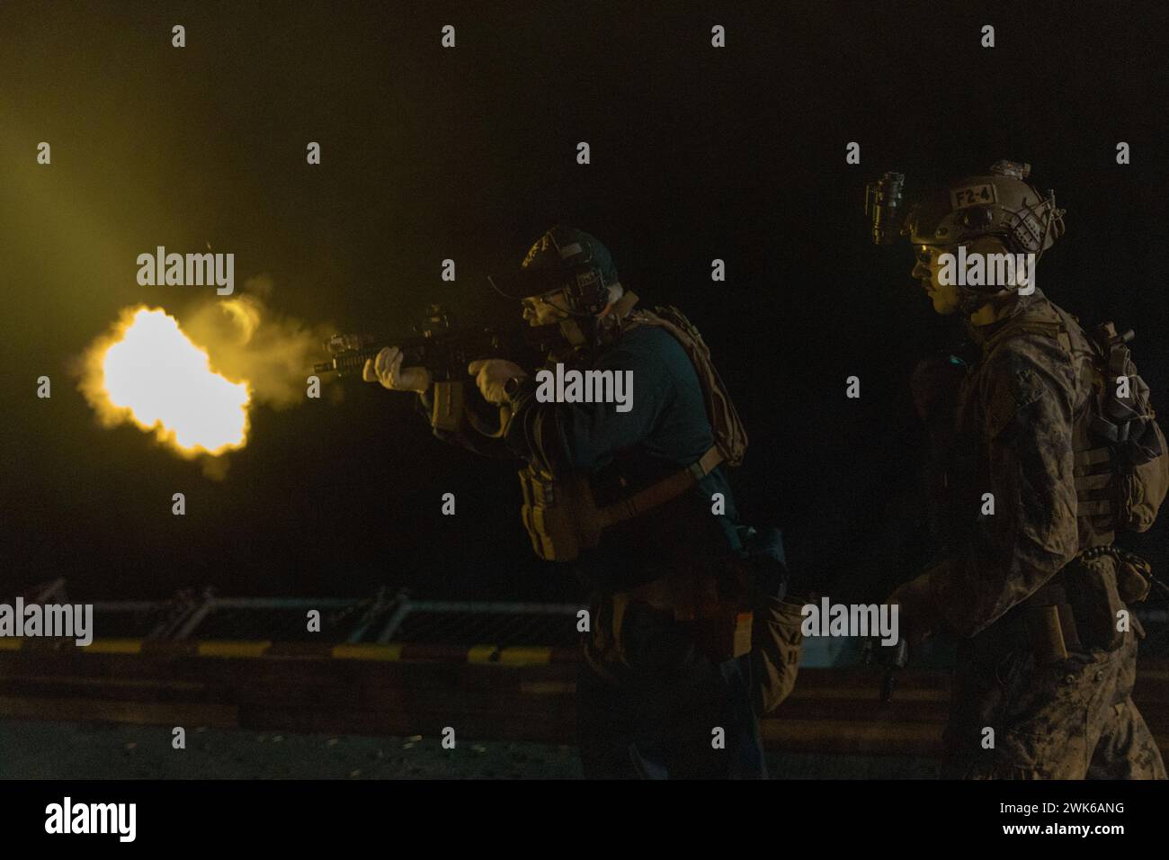 U.S. Navy Chief Petty Officer Jace Jones, center, a small arms ...