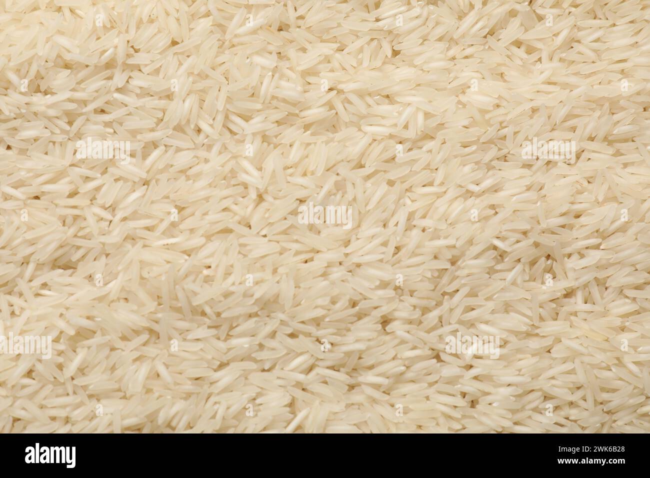 Raw basmati rice as background, top view Stock Photo - Alamy