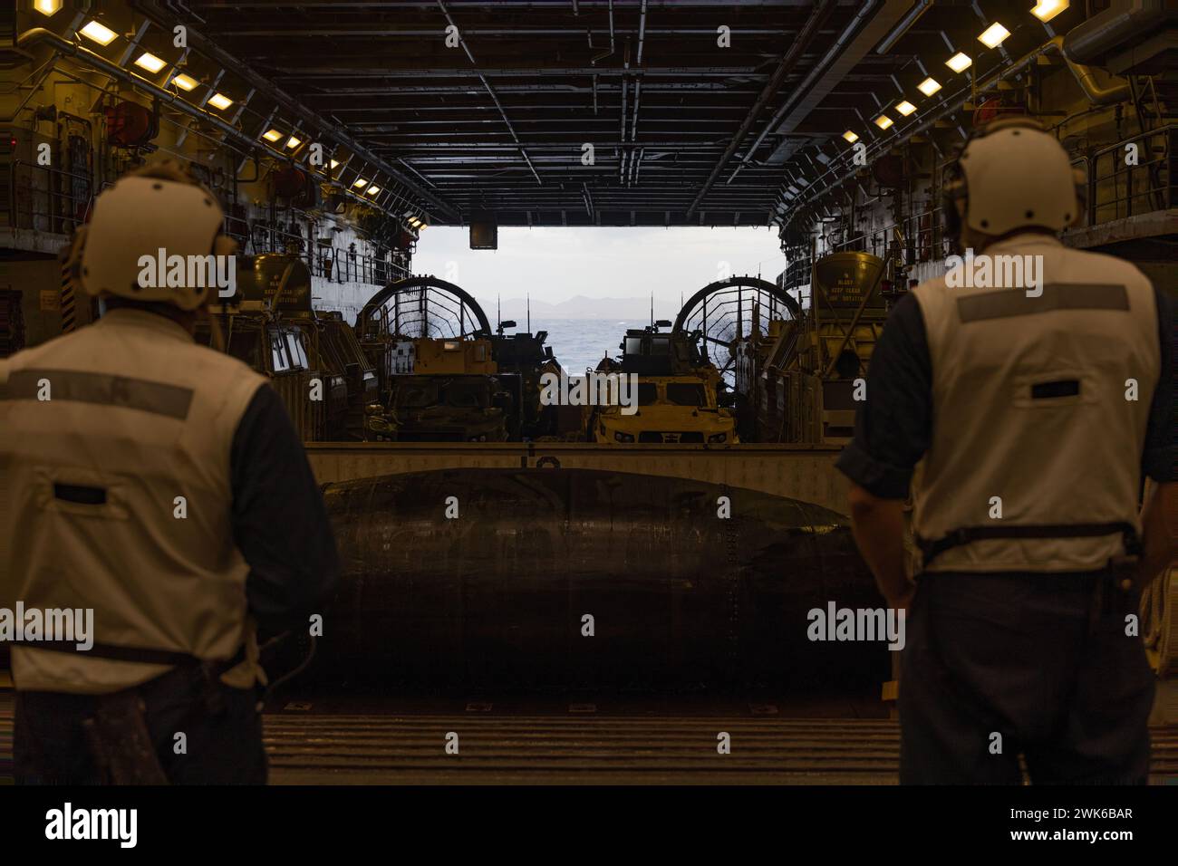 U.S. Navy Sailors with the amphibious dock landing ship USS Green Bay ...