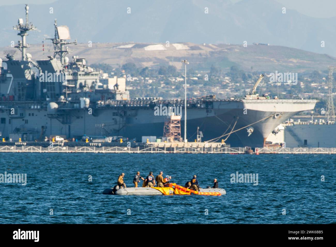 NASA personnel and Sailors assigned to USS San Diego (LPD 22) prepare ...