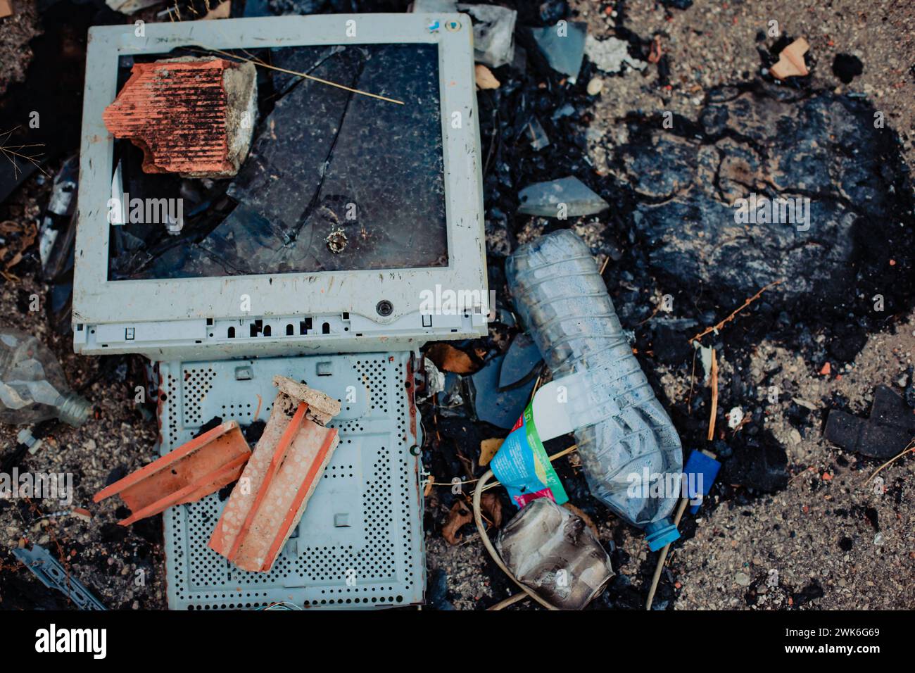 Broken monitor next to bottle and scissors on the ground Stock Photo ...