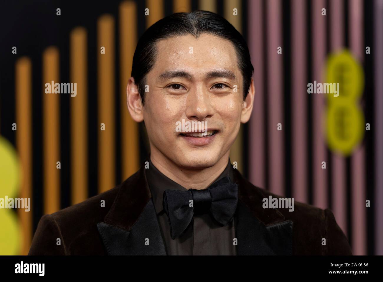 Teo Yoo poses for photographers upon arrival at the 77th British ...