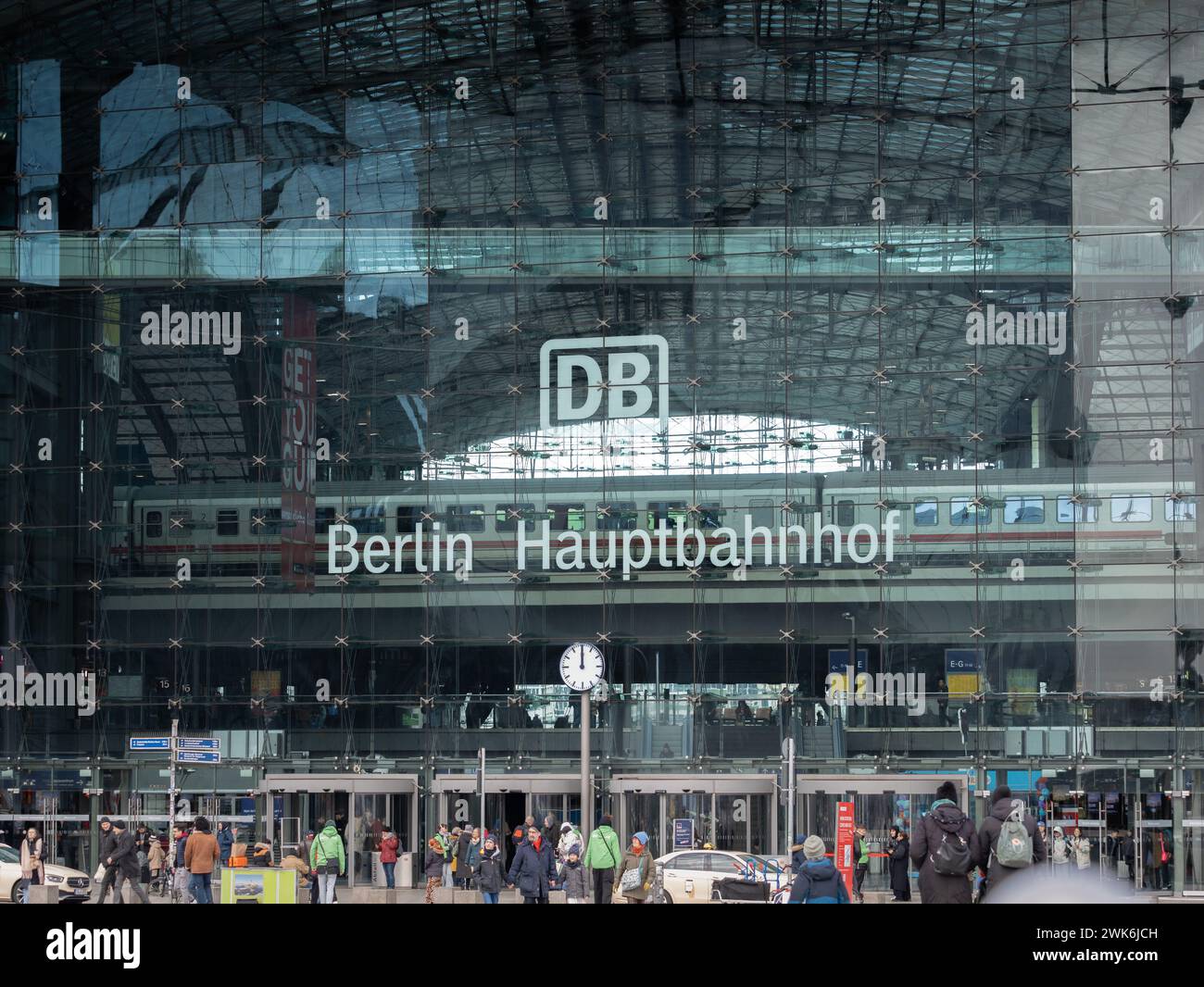 Entrance of the Berlin central station with the big Deutsche Bahn logo ...