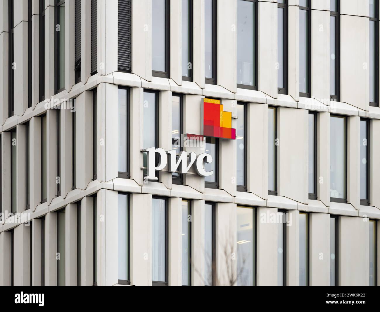 PwC logo sign on an office building. PricewaterhouseCoopers is the name of a big consulting and ...