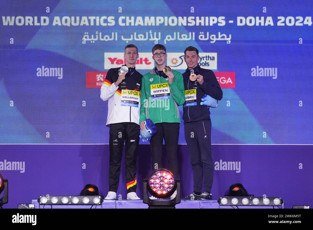 Doha, Qatar. 18th Feb, 2024. Gold medalist Daniel Wiffen (C) of Ireland ...