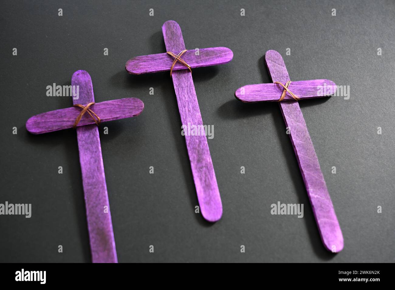 Three purple wooden cross in black background. Christian faith, holy ...