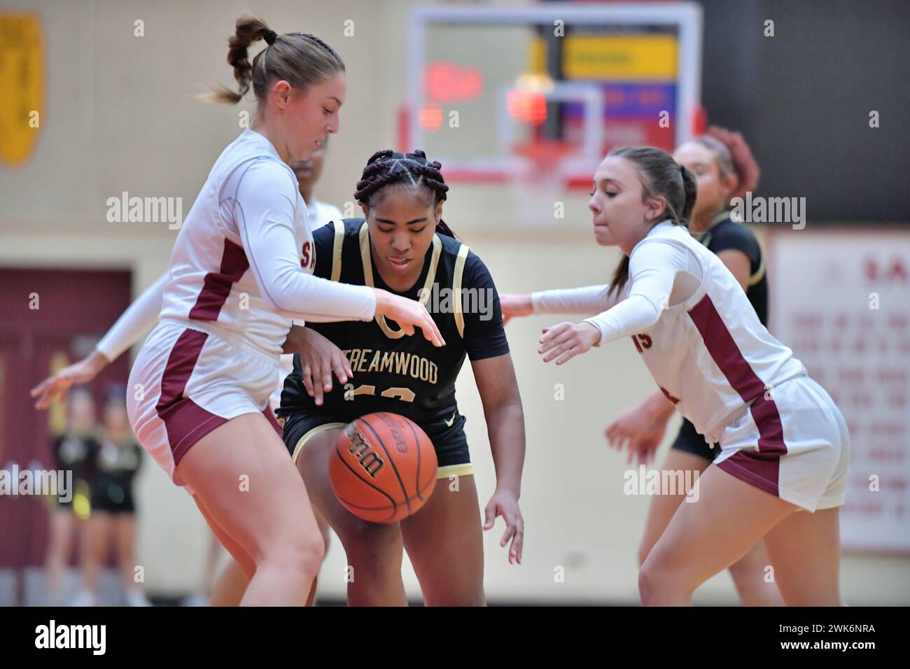 Illinois, USA. Players compete for a loose ball at the top of the key ...