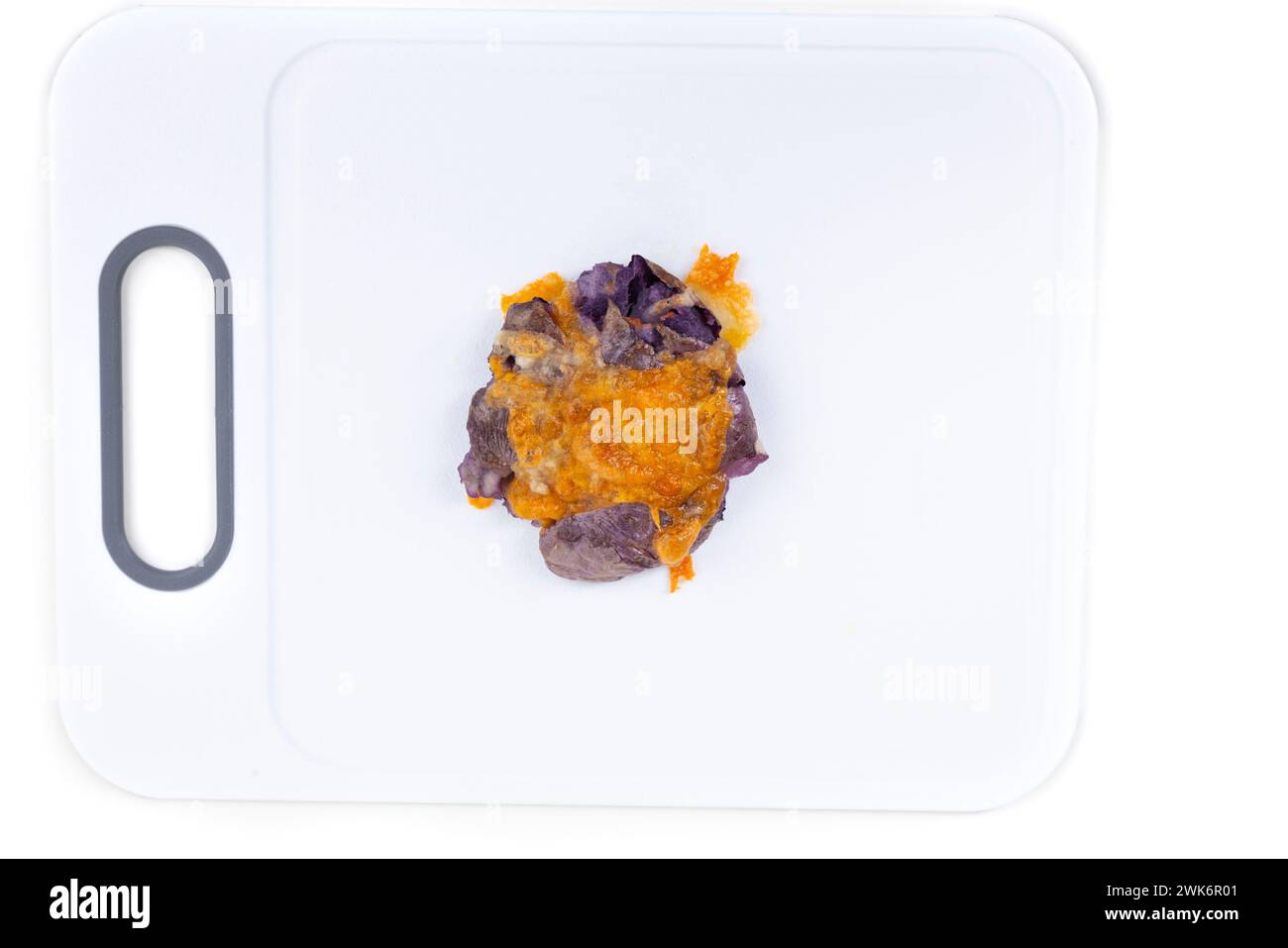 Purple fried smashed potato on a cutting board top down Stock Photo - Alamy