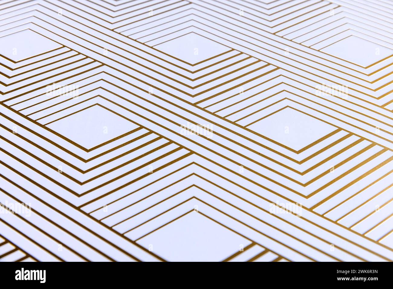 Shiny gold geometric lines on white paper from an angle Stock Photo - Alamy