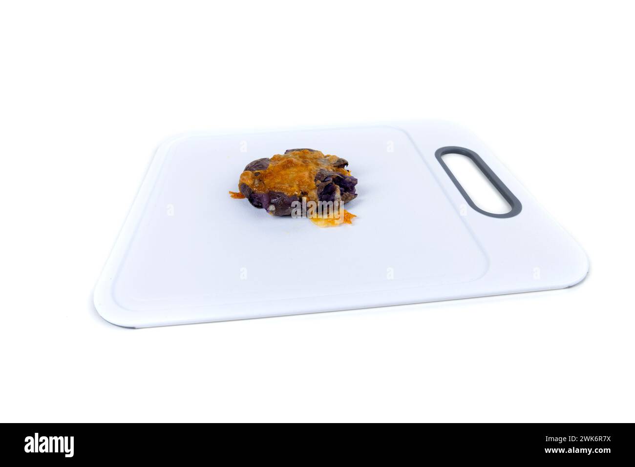 Purple fried smashed potato on a cutting board Stock Photo - Alamy