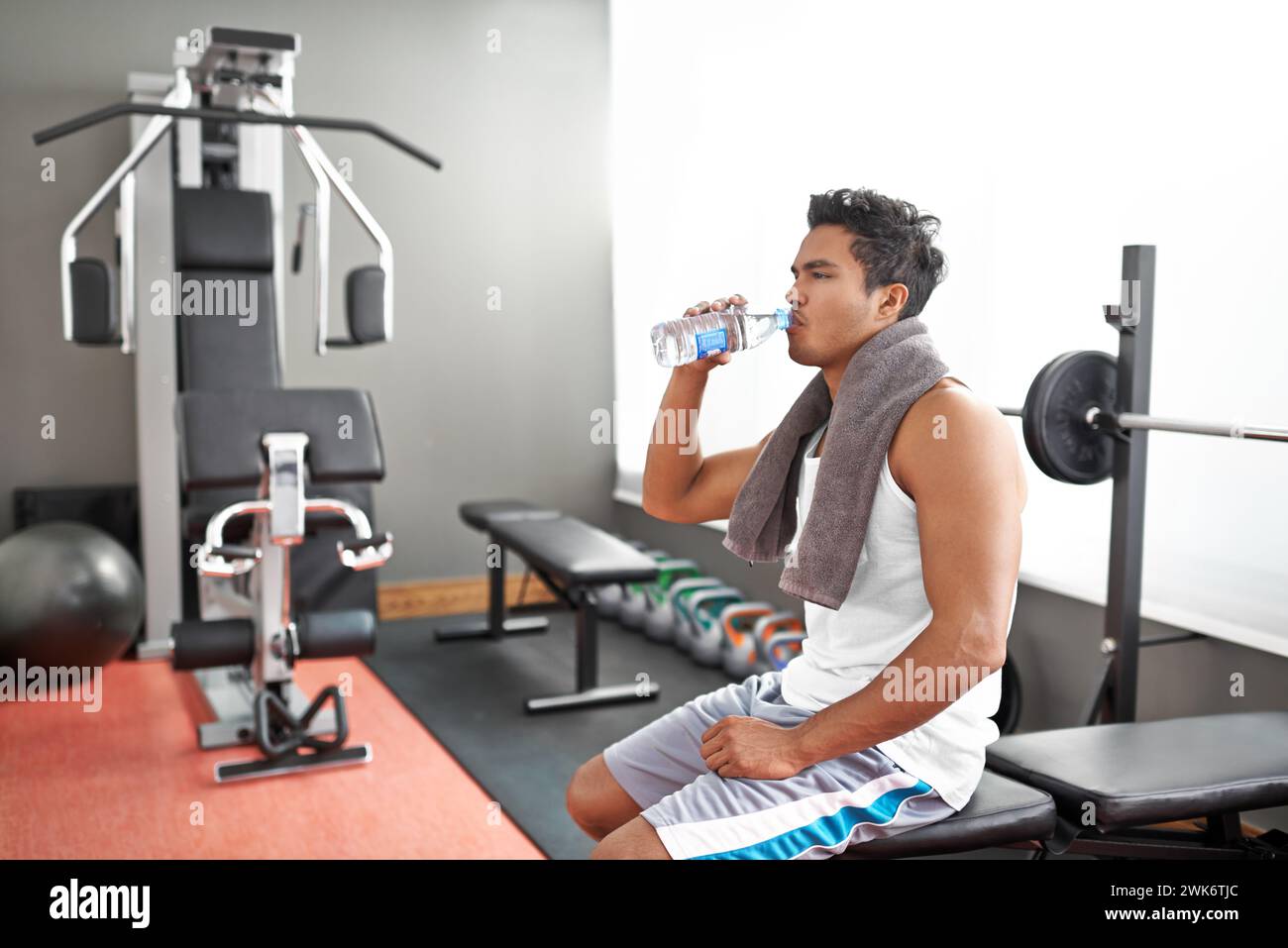 Fitness, gym and man drinking water for training, wellness or exercise ...